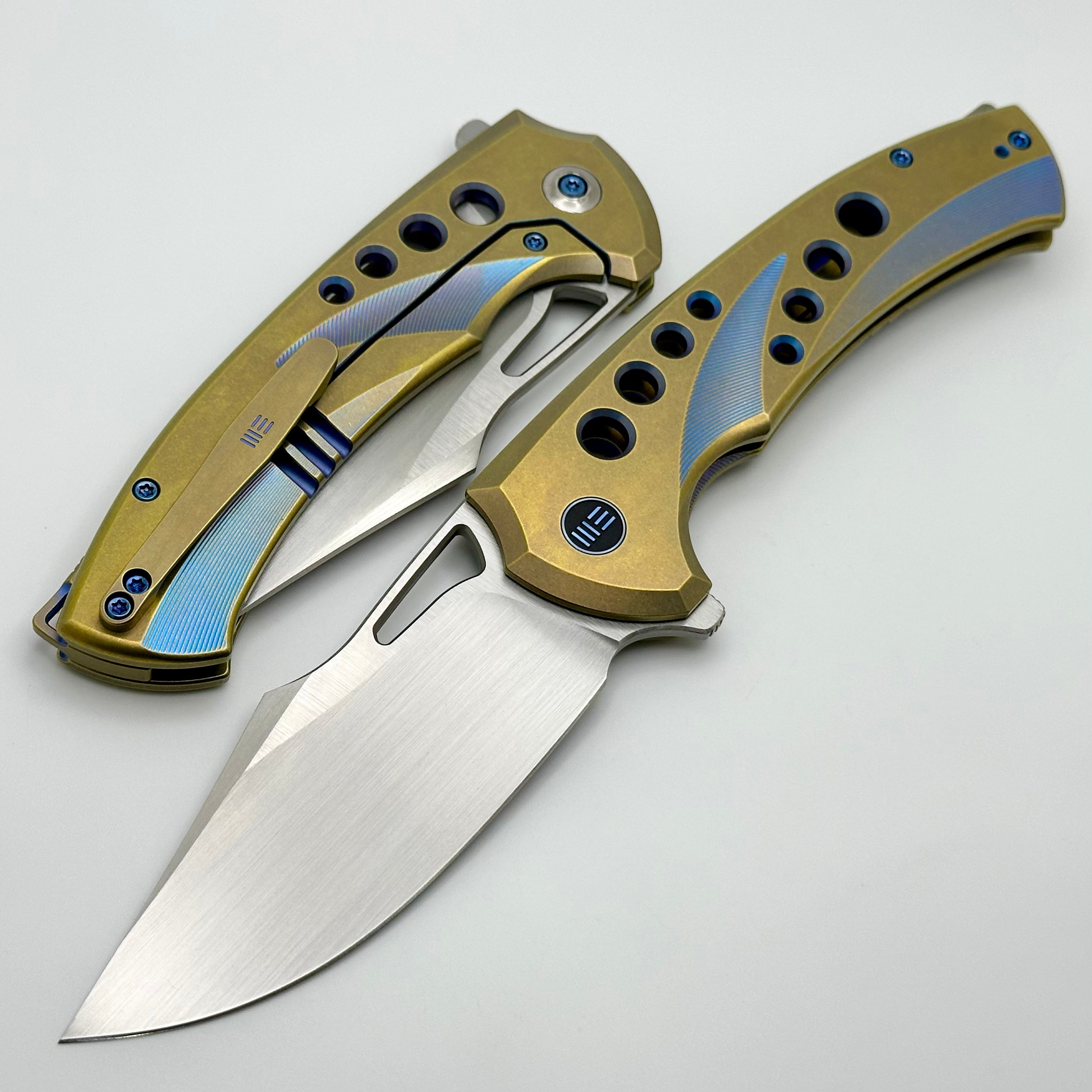 We Knife Swiftfin Golden/Blue Titanium Handles w/ Blue Holes & Hand Sa